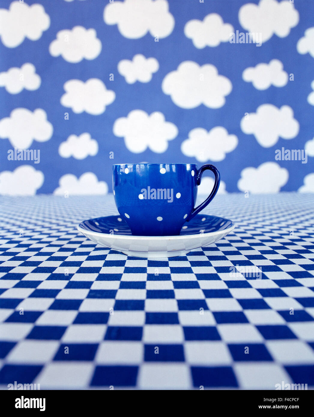A Spotted Cup on a Checked and Cloudy Background Stock Photo - Alamy