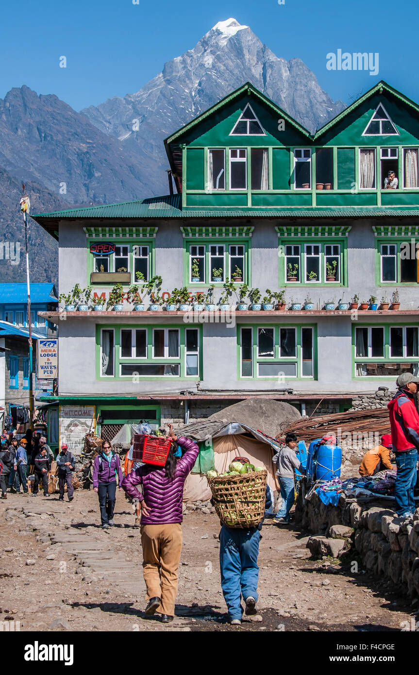 Porters carrying loads in front of teahouse, Lukla, Nepal Stock Photo ...