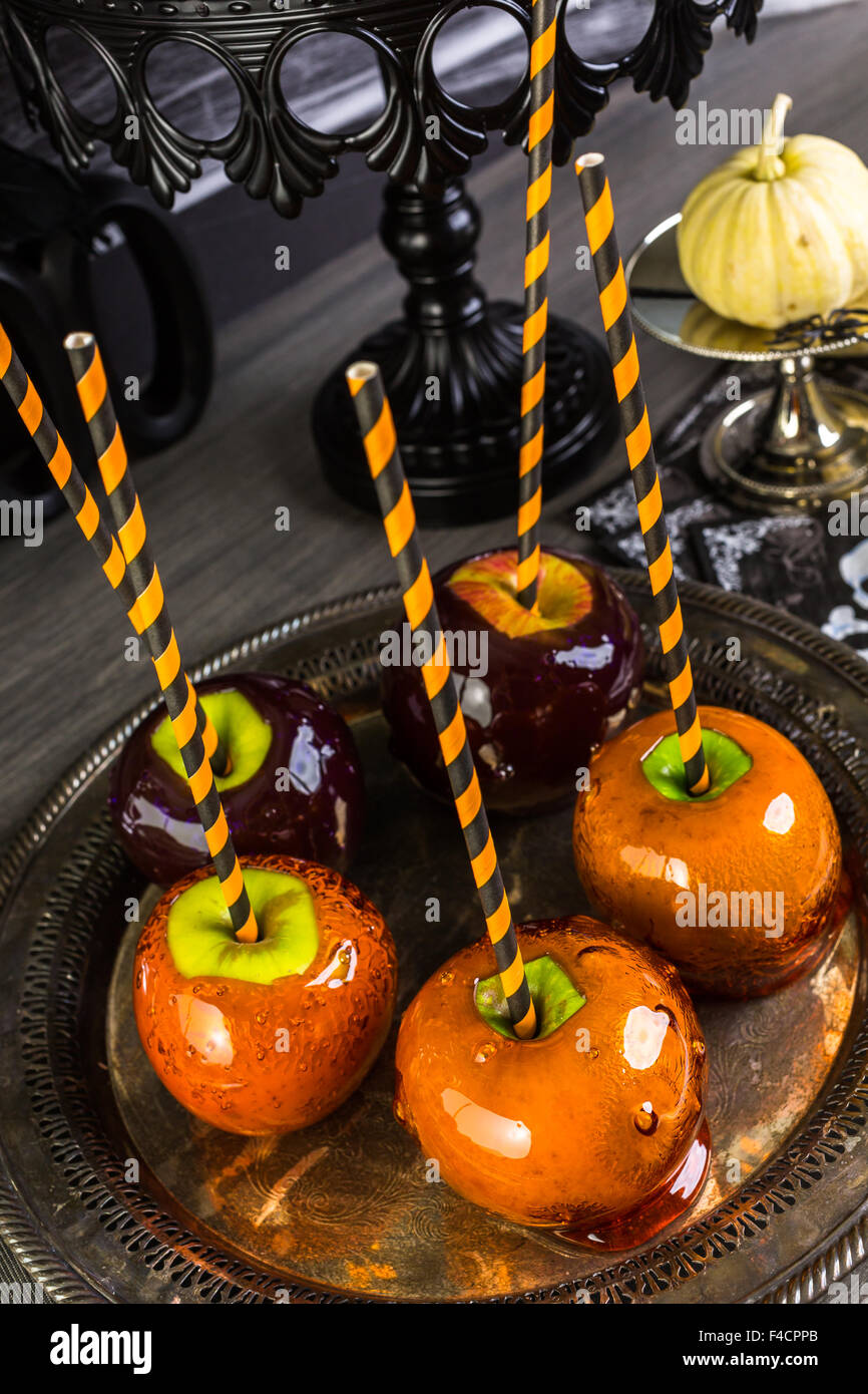 Table with colored candy apples for Halloween party Stock Photo - Alamy