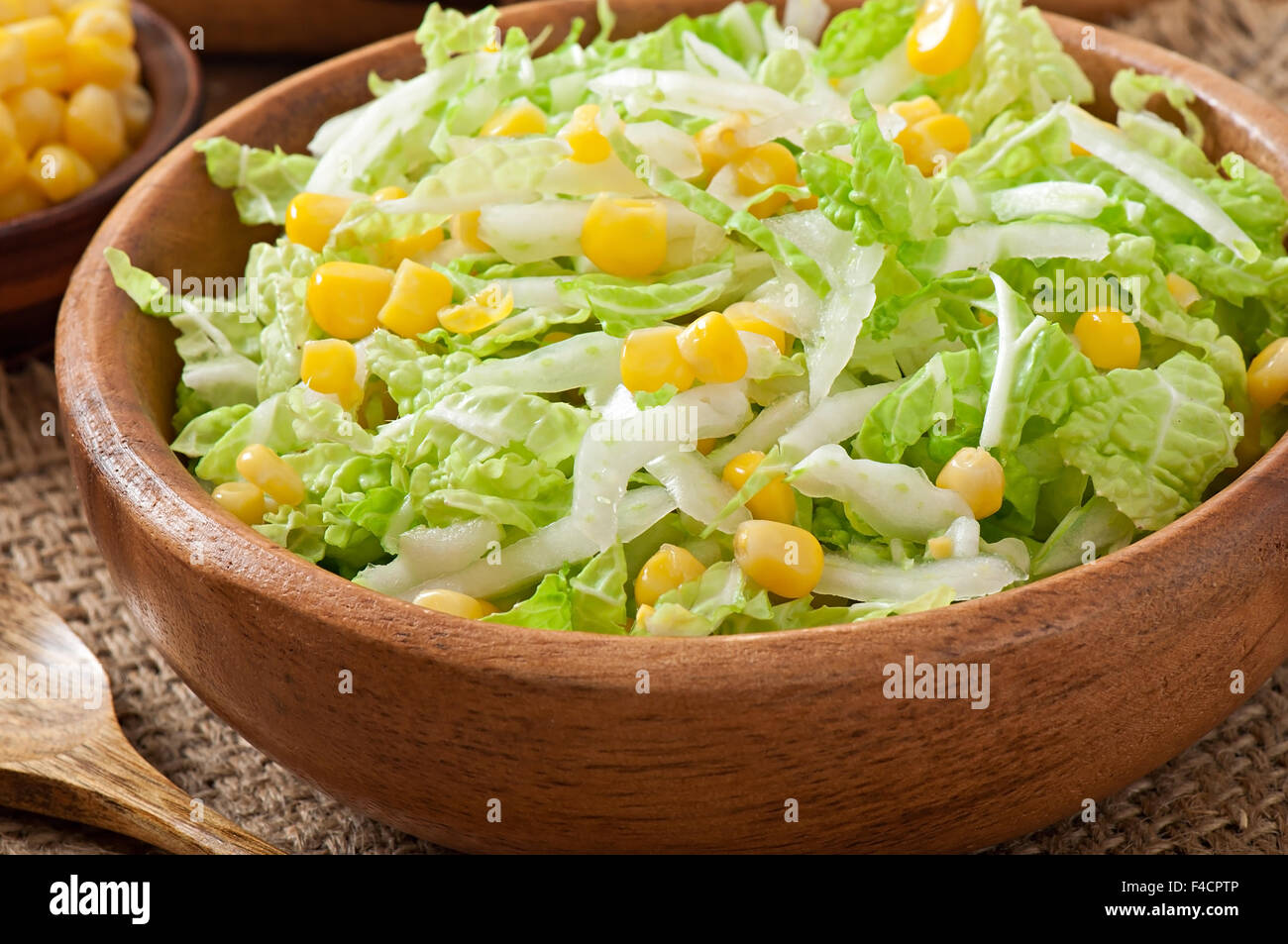 Chinese cabbage salad with sweet corn in a wooden bowl Stock Photo - Alamy