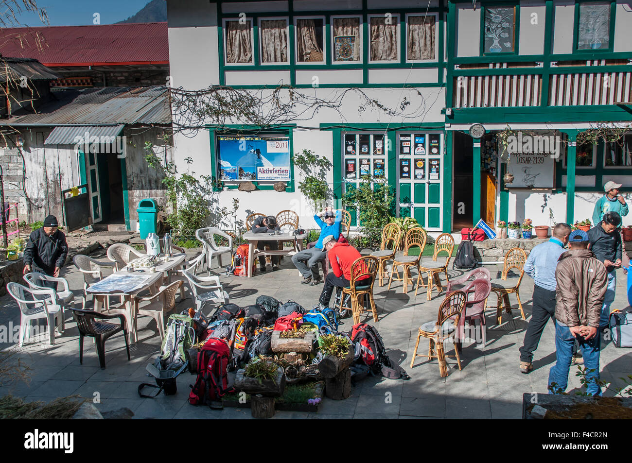 Trekkers resting in teahouse courtyard, Lukla, Nepal Stock Photo - Alamy