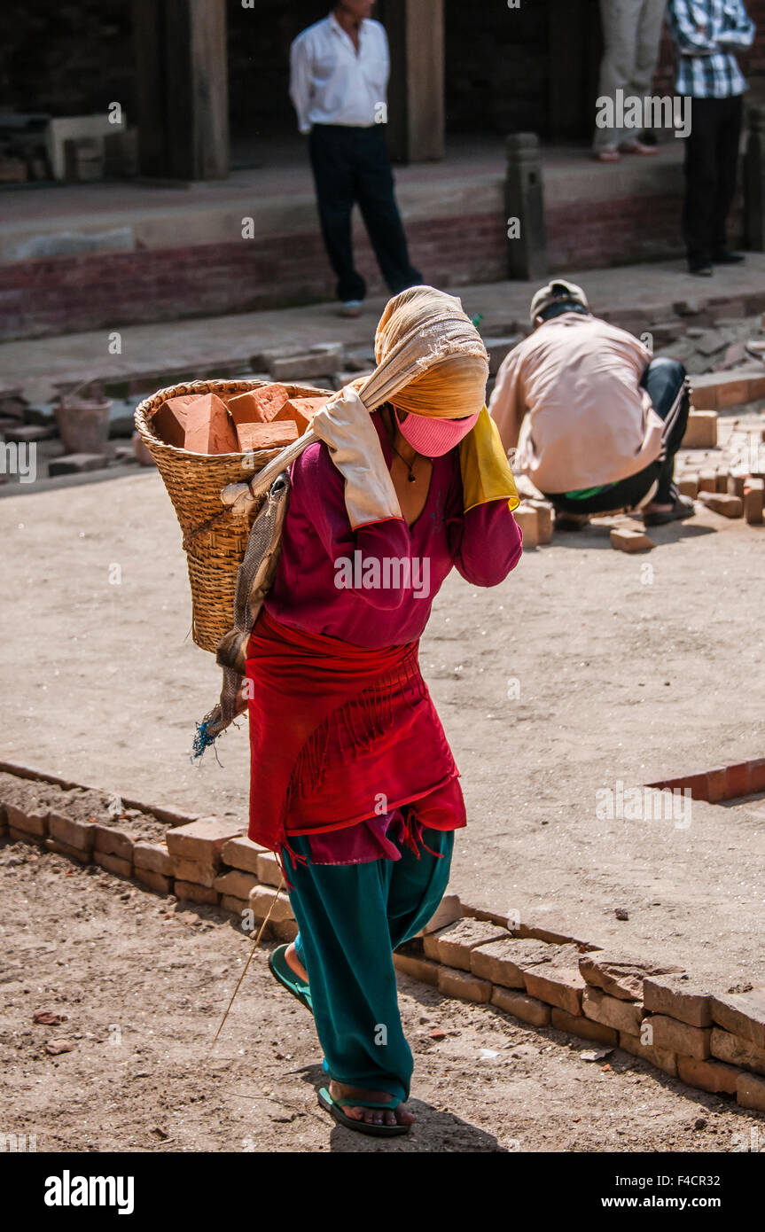 Woman carrying bricks in basket, Bhaktapur, Kathmandu, Nepal Stock ...