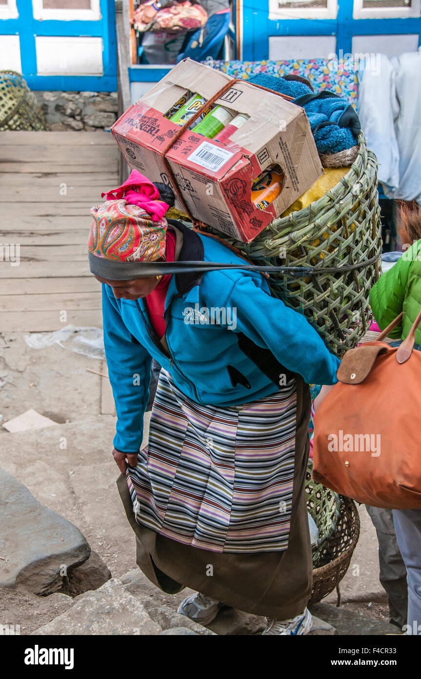 Woman carrying heavy load, Namche Bazaar, Solukhumbu, Nepal Stock Photo ...