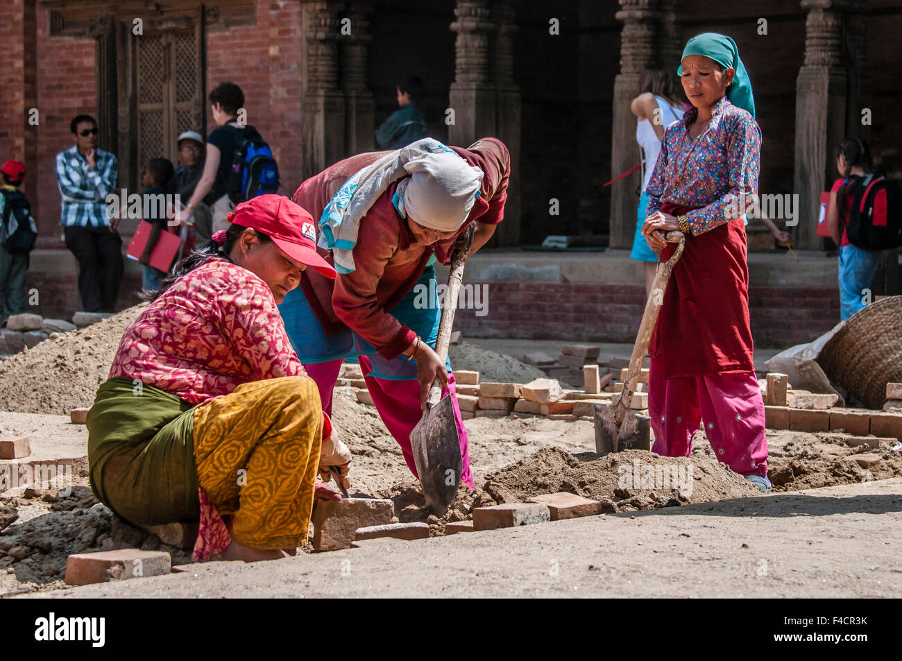 Women shoveling sand hi-res stock photography and images - Alamy