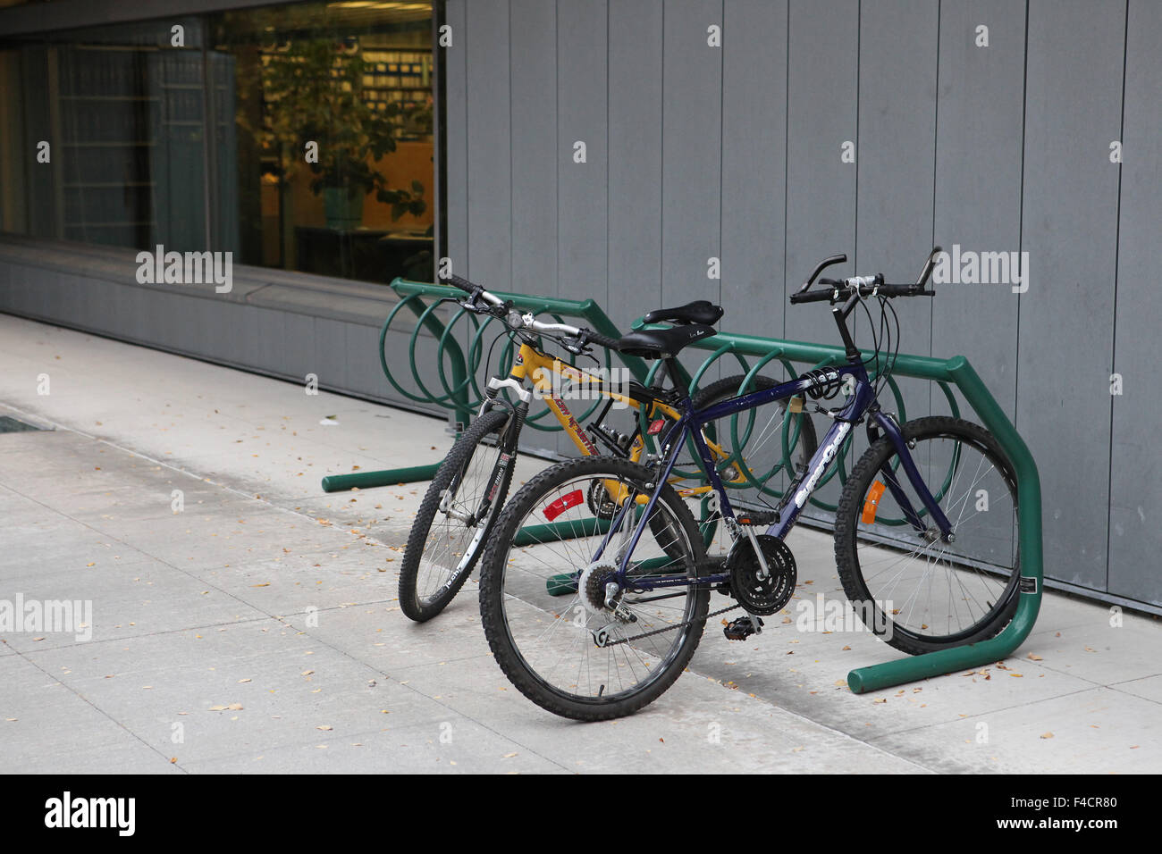 Two bicycles in a bike rack Stock Photo - Alamy