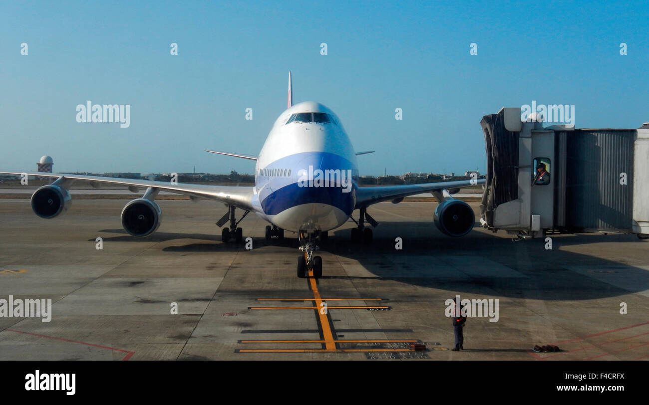 A Boeing 747 airplane approaching a gate at Taiwan Airport Stock Photo ...