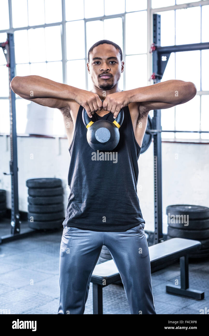 Fit man working out with kettlebell Stock Photo - Alamy