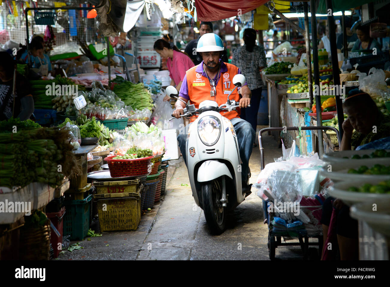 Thailand, Bangkok. Man riding motor scooter through market. (Large ...