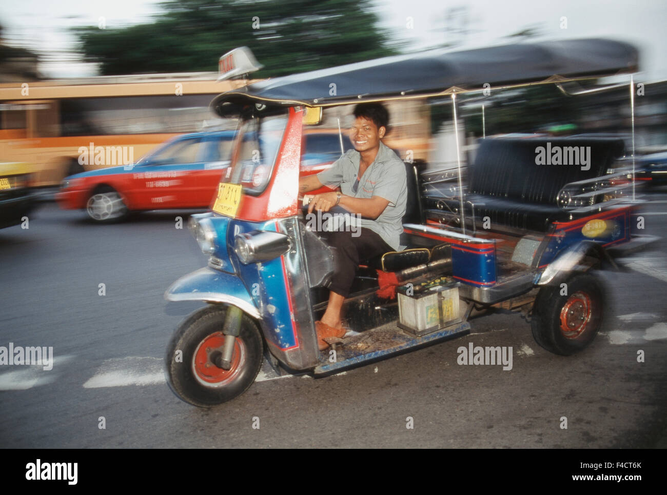 Thailand, Bangkok, Man driving Tuk Tuk, blurred motion. (Large format ...