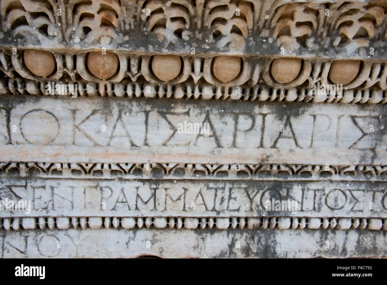 Turkey, Ephesus. Ancient Ephesian ruins, marble carved text with dart ...