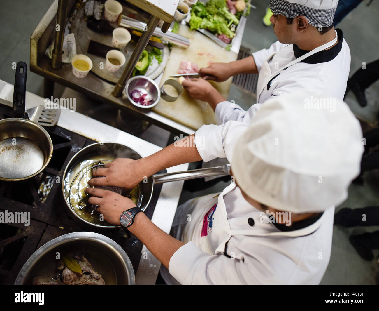 New Delhi, India. 16th Oct, 2015. Participants cook during the Chinese ...