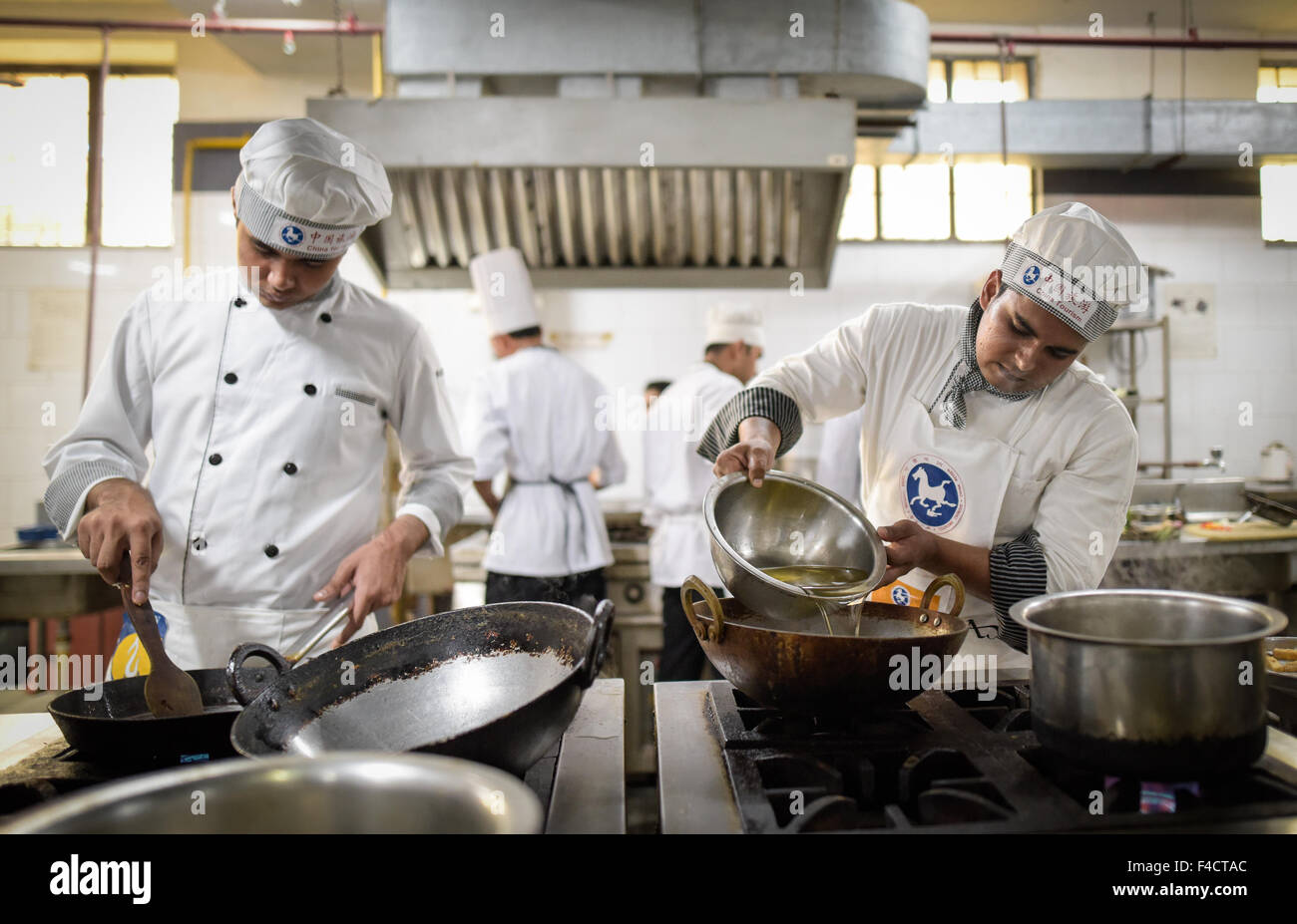 New Delhi, India. 16th Oct, 2015. Participants cook during the Chinese ...