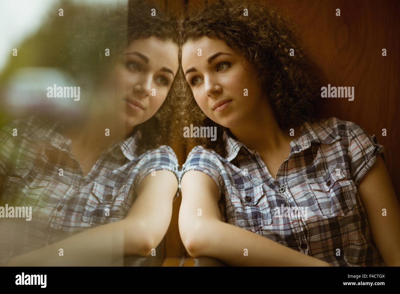 Pretty student sitting by the window Stock Photo - Alamy