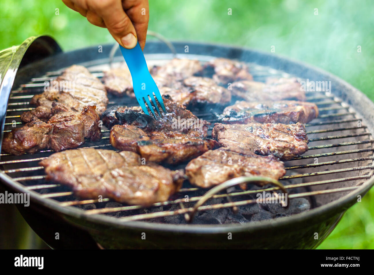 Grilling pork meat with barbecue stuff. Horizontal close up shot Stock ...