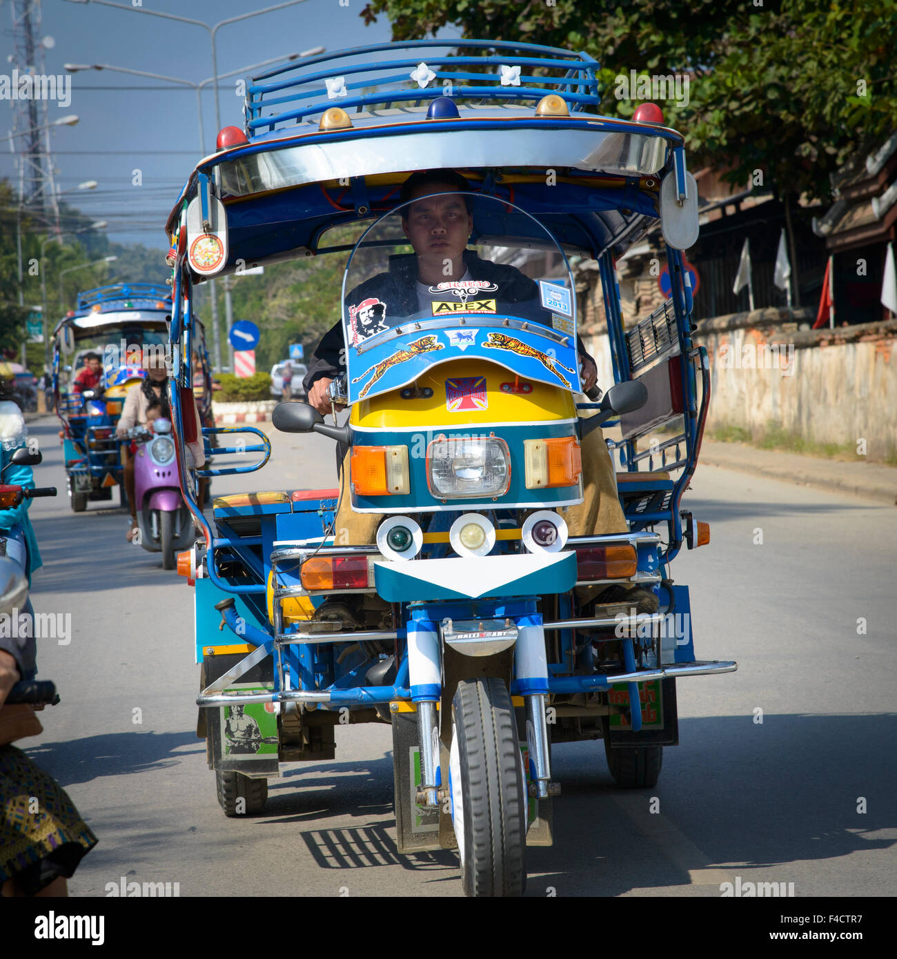Laos, Luang Prabang. Man driving tuk-tuk Stock Photo - Alamy