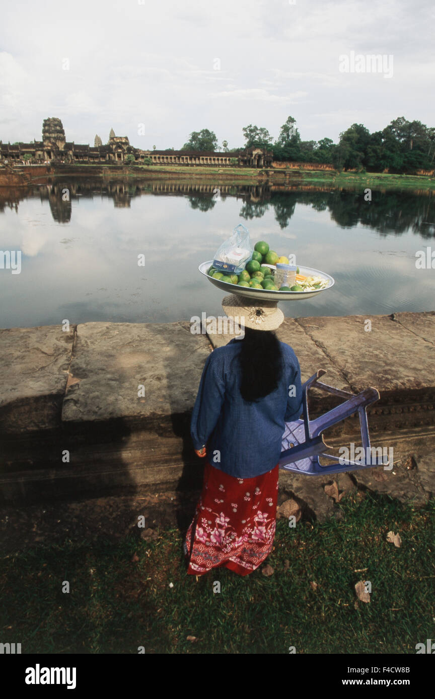 Cambodia, Siem Reap Province, Angkor Wat, Woman carrying on fruit plate ...