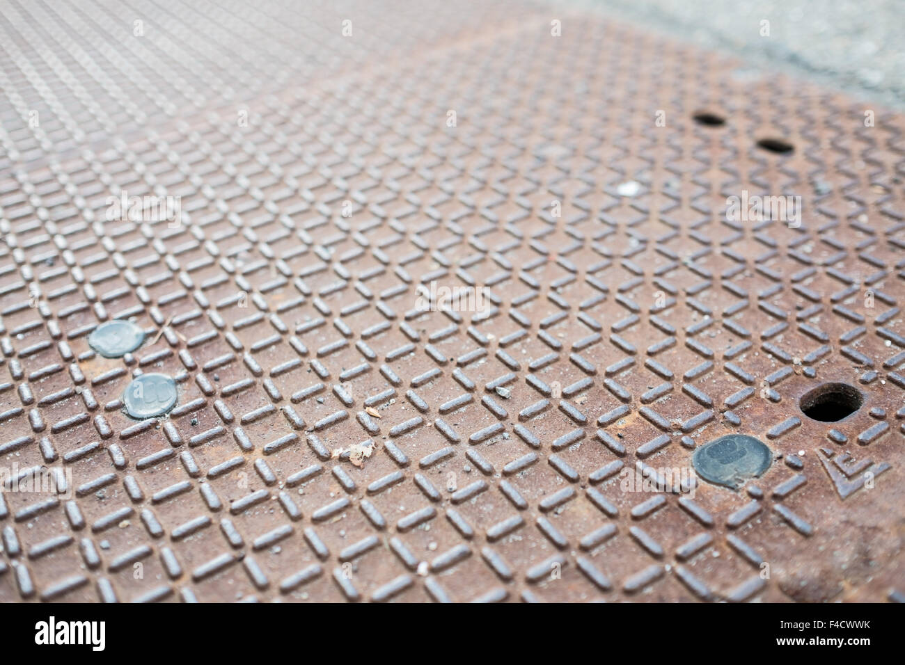Manhole cover of steel with rust as background Stock Photo - Alamy