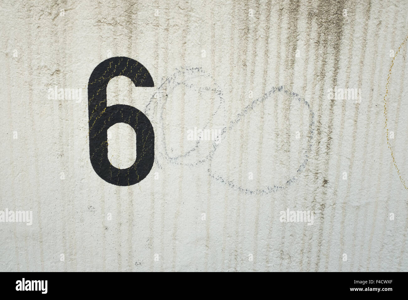 Number 6 in black on a beige wall Stock Photo - Alamy