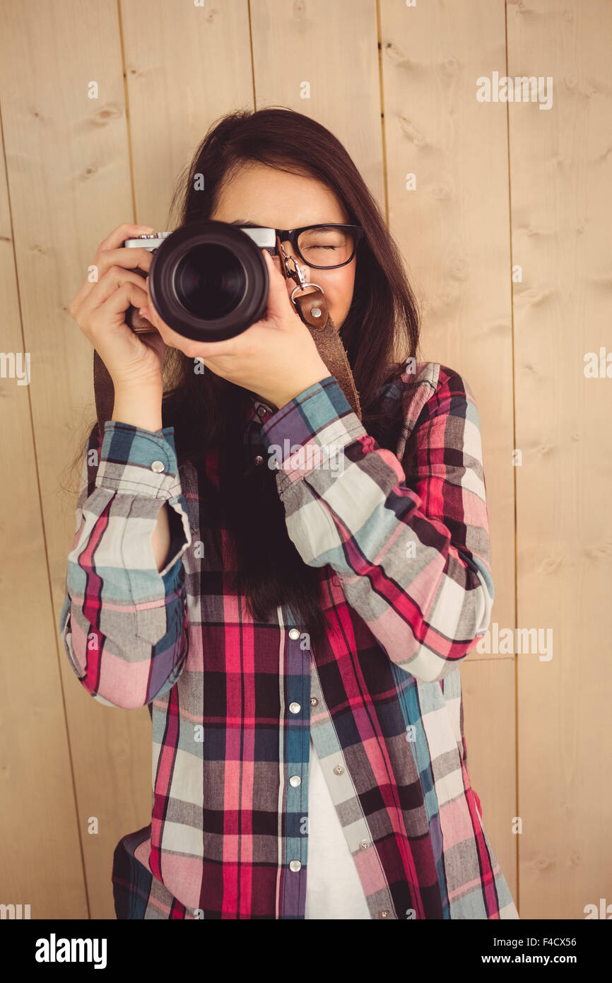 Attractive hipster photographing with camera Stock Photo - Alamy
