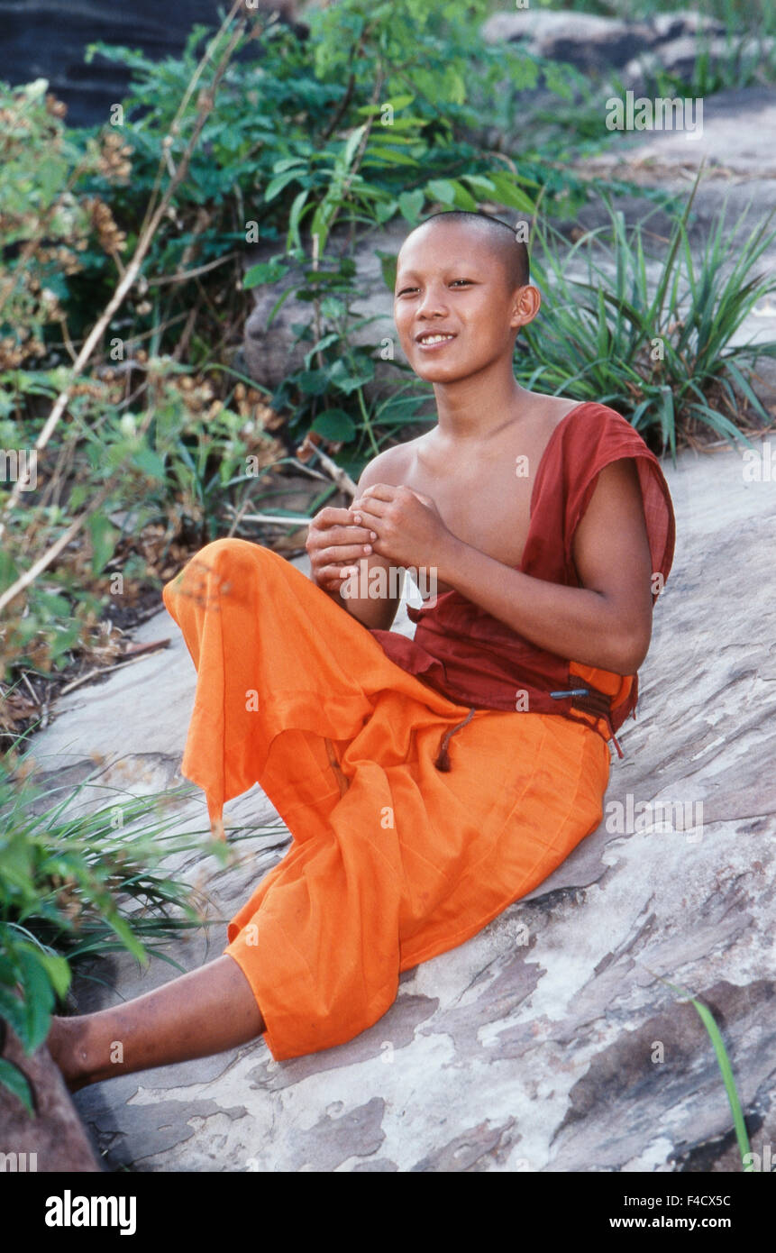 Cambodia, Monk sitting on rock. (Large format sizes available Stock ...