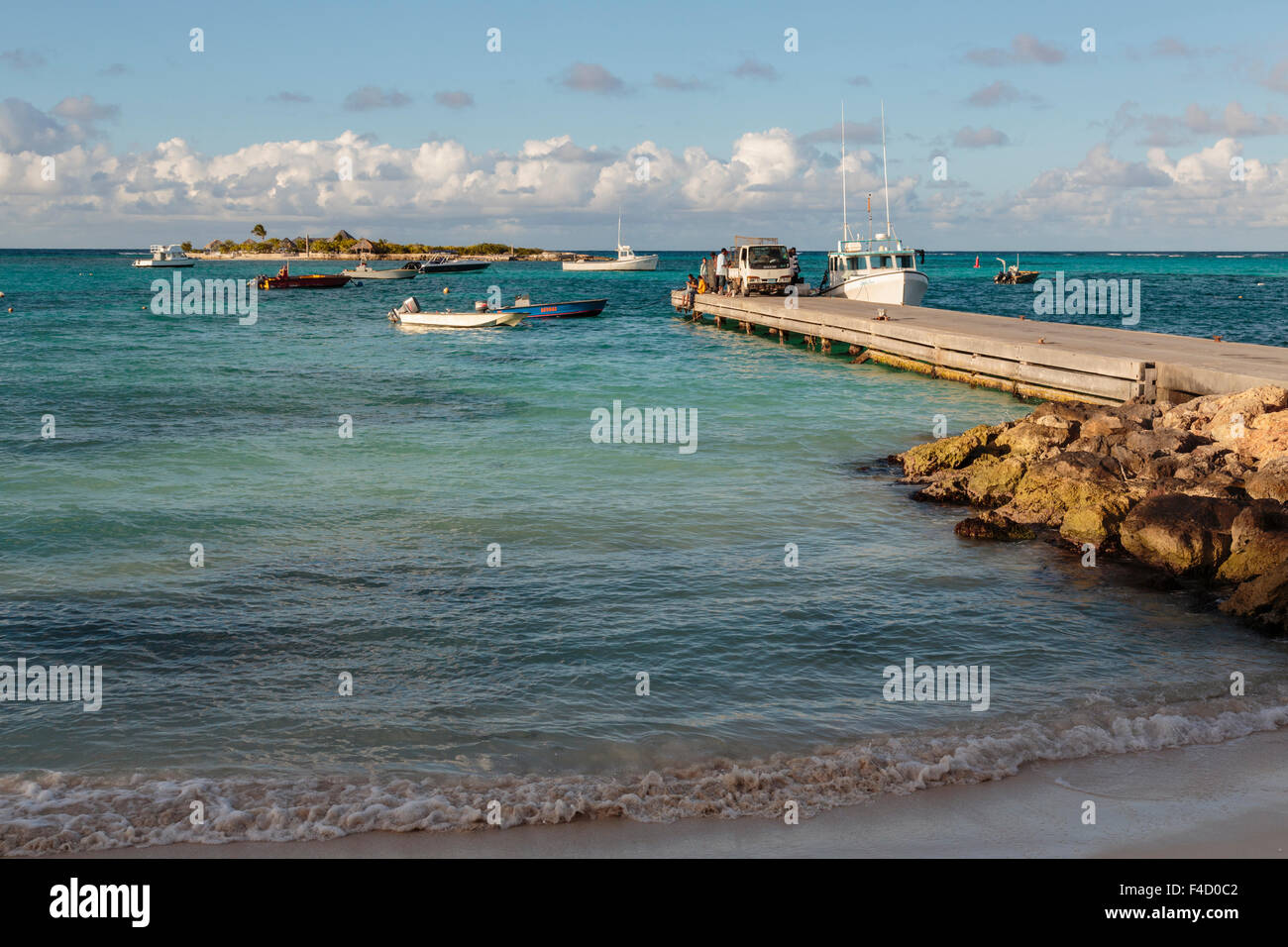 Caribbean, Anguilla. Fishing boat unloading daily catch on dock Stock ...
