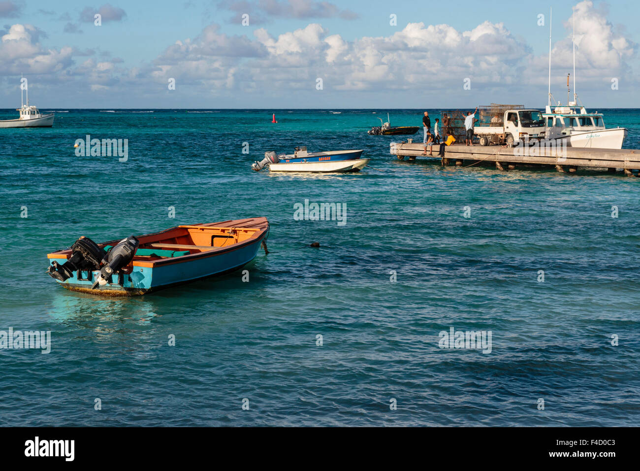 Caribbean, Anguilla. Fishing boat unloading daily catch on dock Stock ...