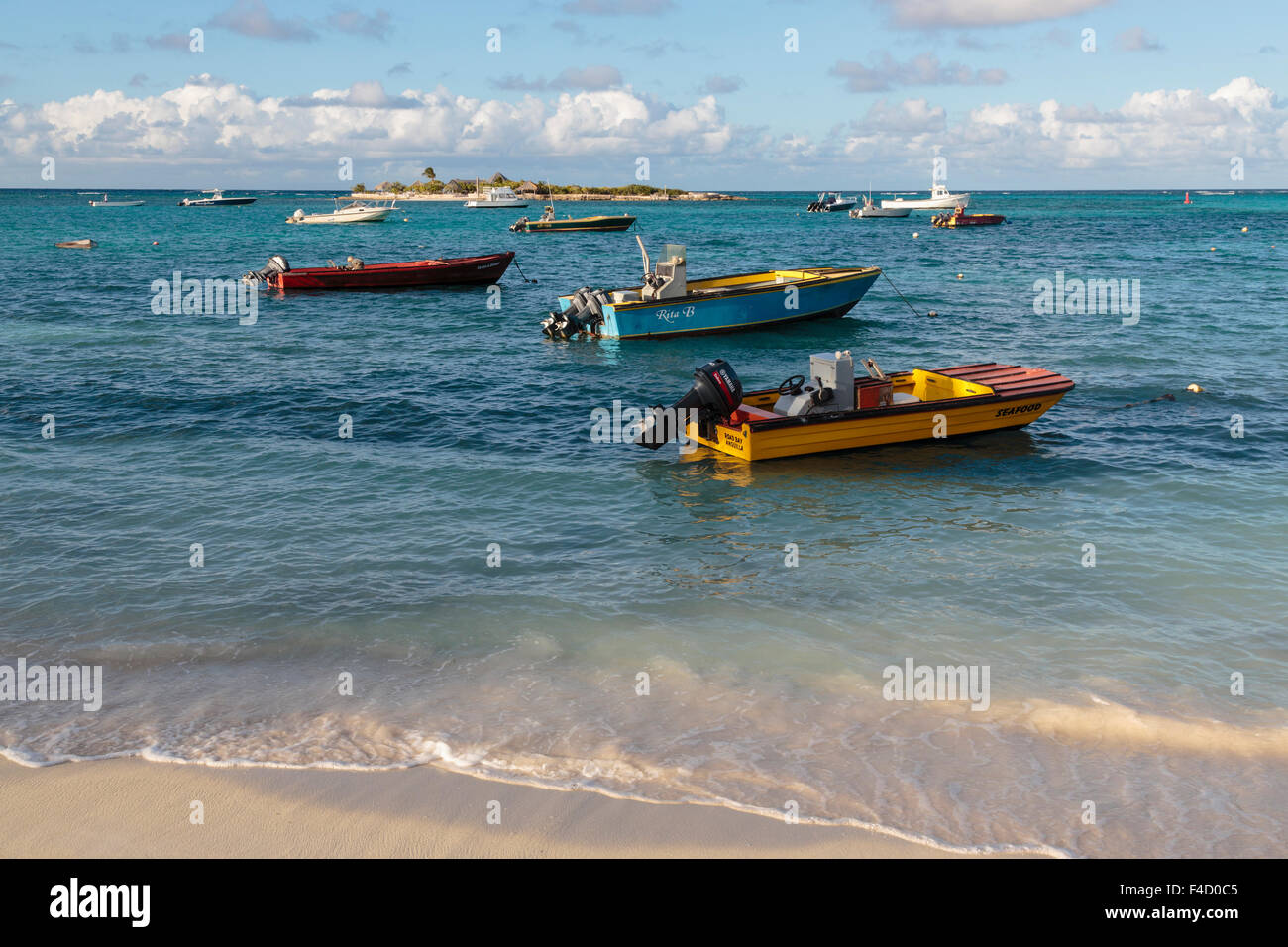 Caribbean, Anguilla. Fishing boat unloading daily catch on dock Stock ...