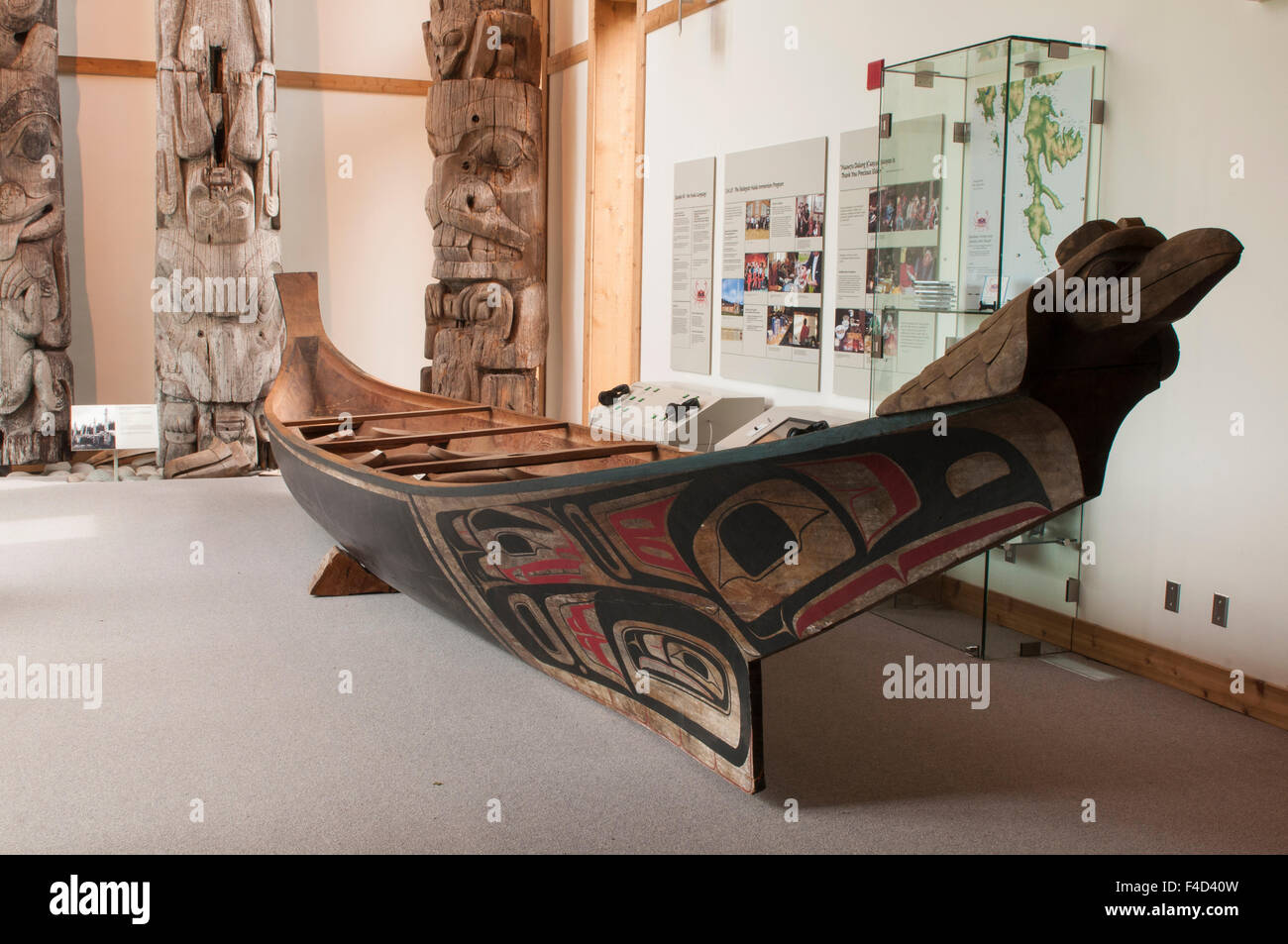 First Nation canoe and totem poles at Haida Heritage Centre Museum at ...