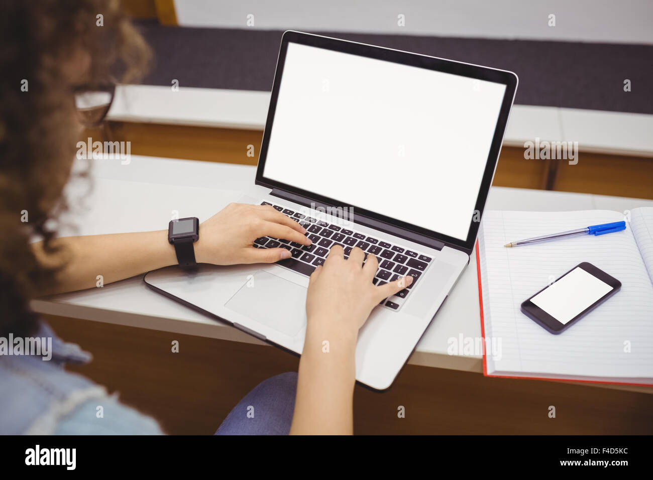 Pretty student in lecture hall with smartwatch Stock Photo - Alamy