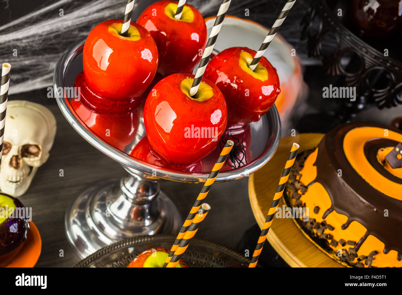 Table with colored candy apples and cake for Halloween party Stock ...