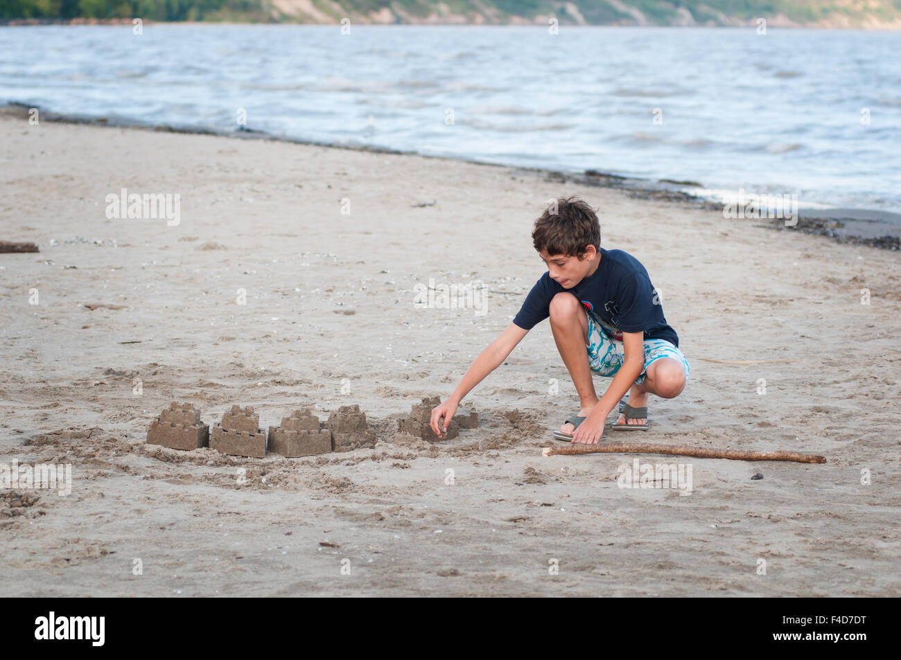 Boy building sandcastle on beach hi-res stock photography and images ...