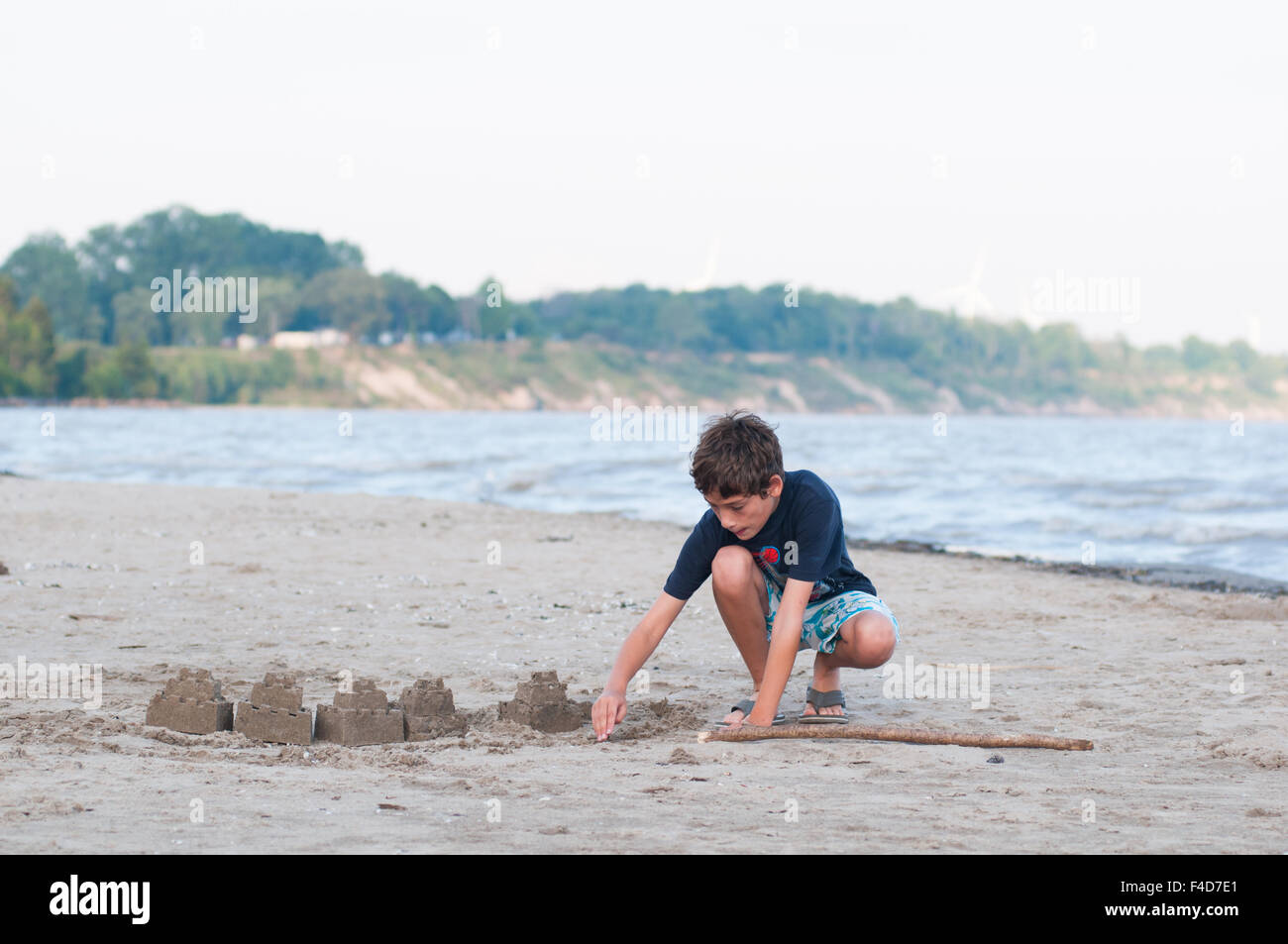 Boy building sandcastle on beach hi-res stock photography and images ...
