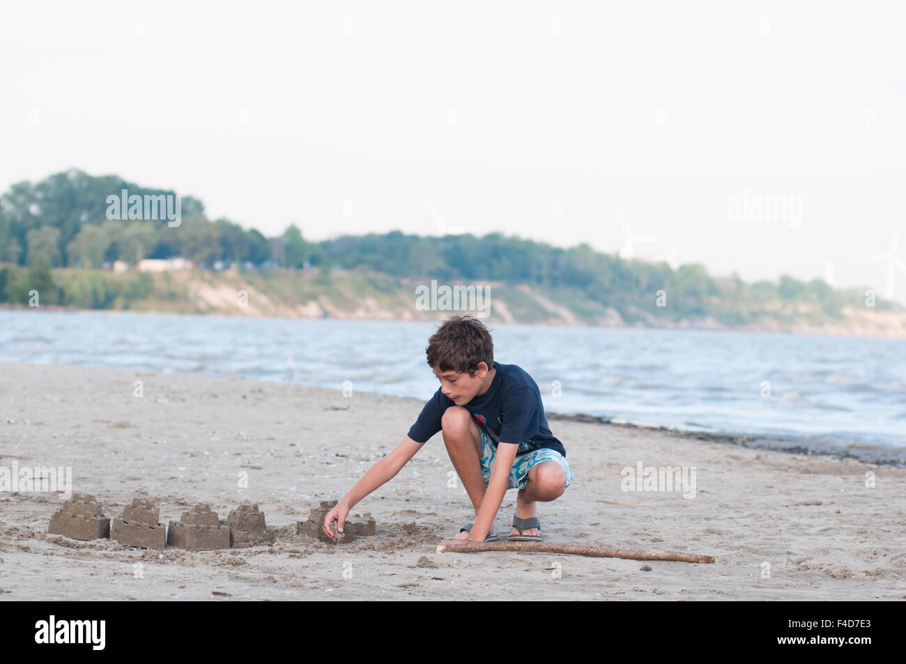 Boy building sandcastle on beach hi-res stock photography and images ...