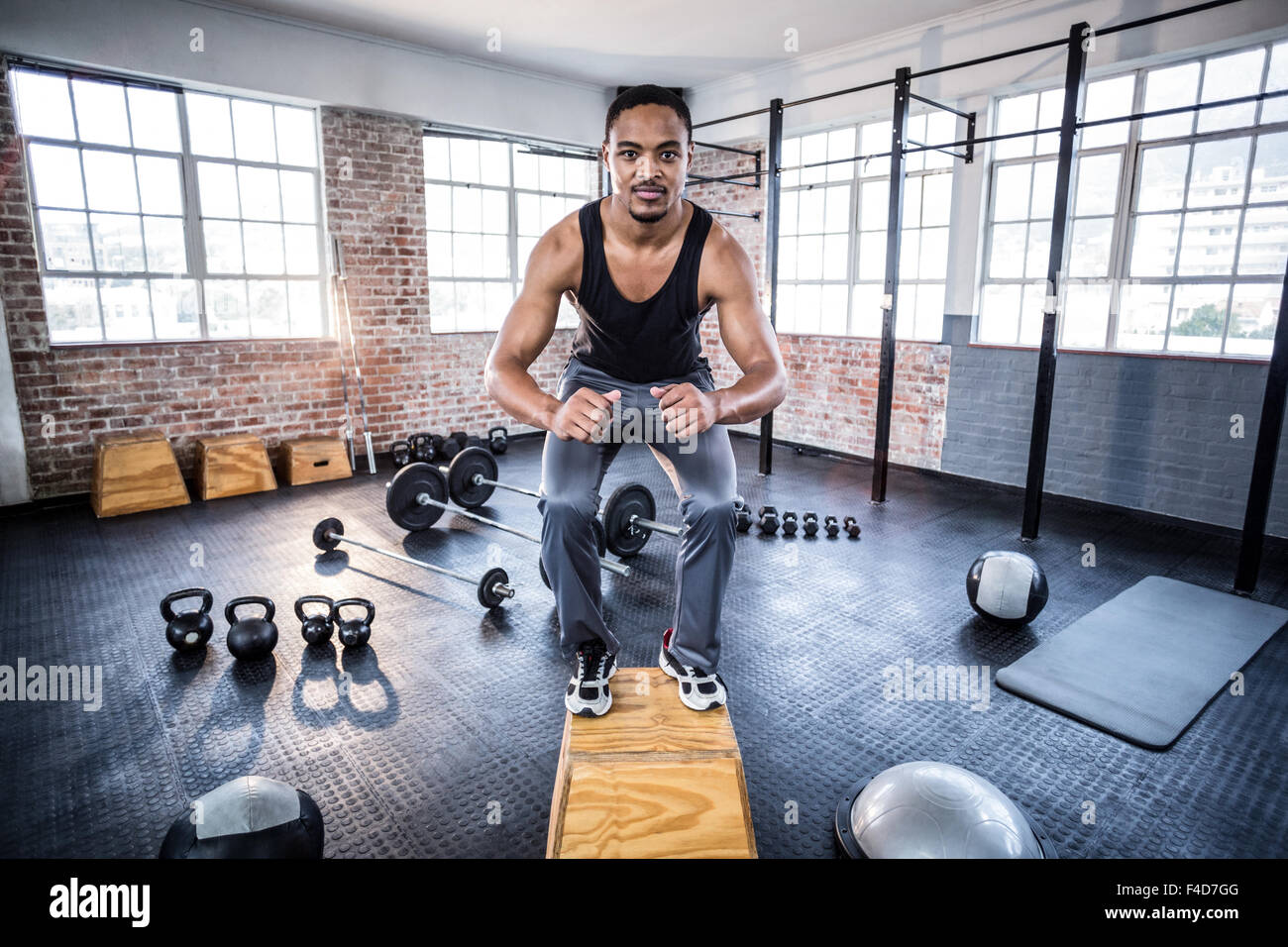 Muscular man doing stretching exercises on box Stock Photo - Alamy