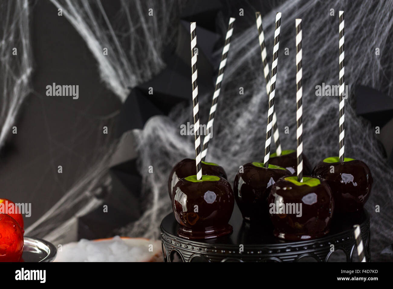 Table with colored candy apples and cake for Halloween party Stock ...