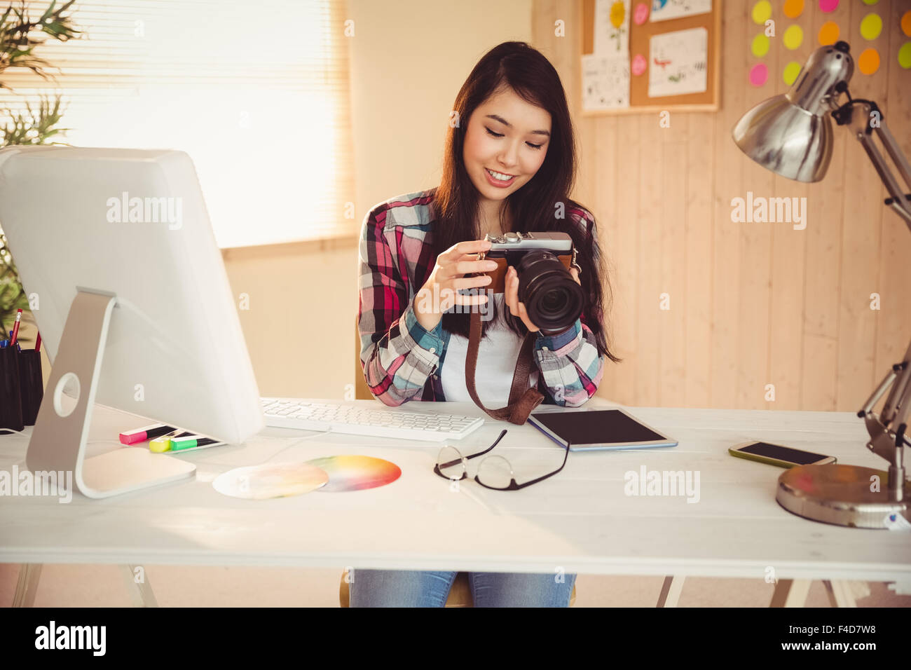 Happy photographer holding her camera Stock Photo - Alamy