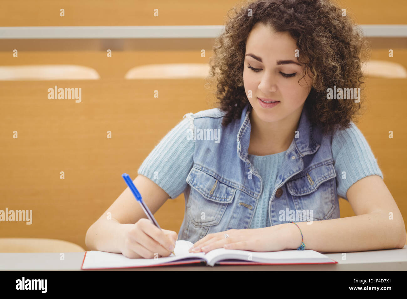 Happy student in lecture hall Stock Photo - Alamy