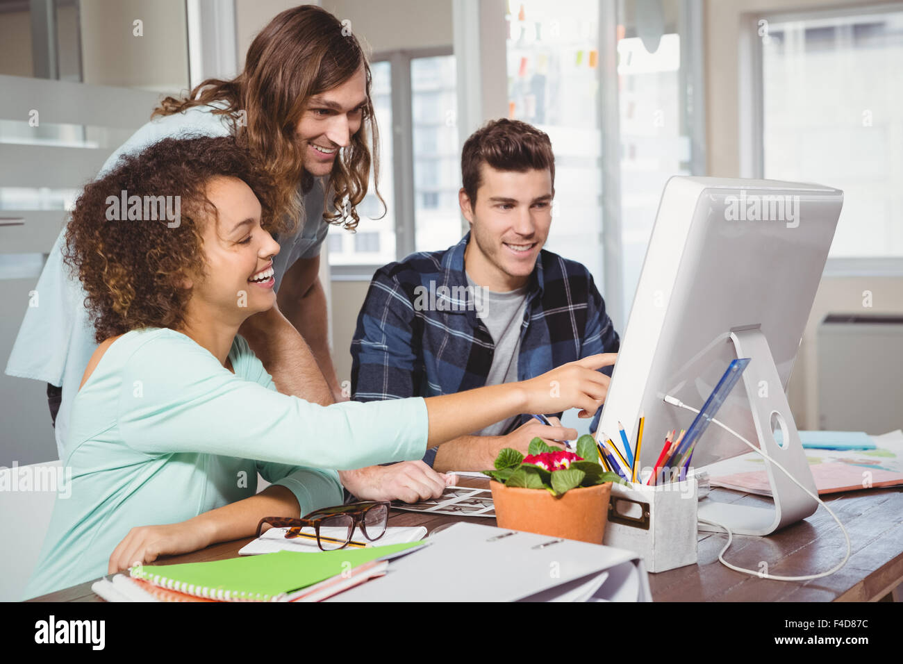 Business people smiling while looking at computer Stock Photo - Alamy