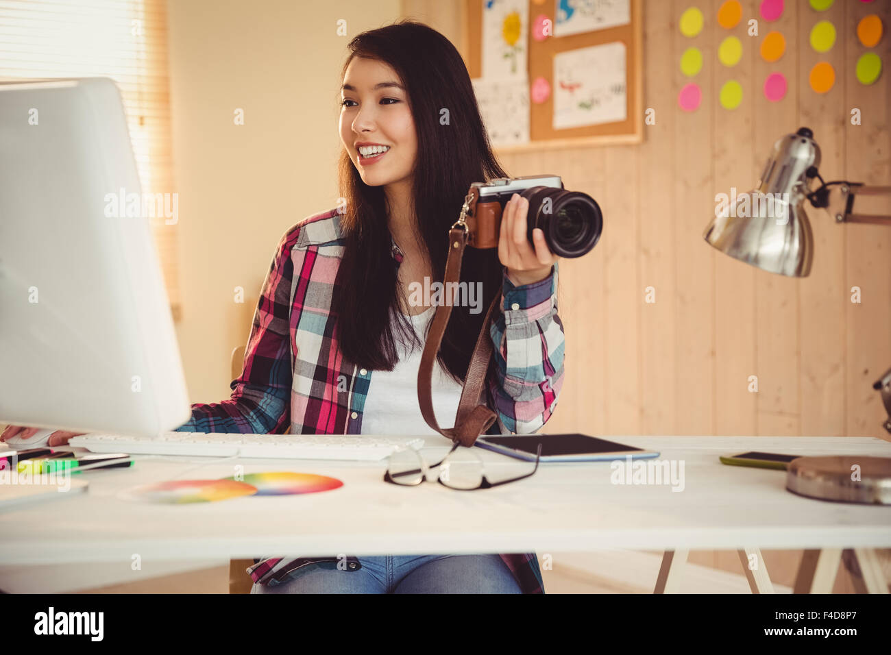 Happy photographer holding her camera Stock Photo - Alamy