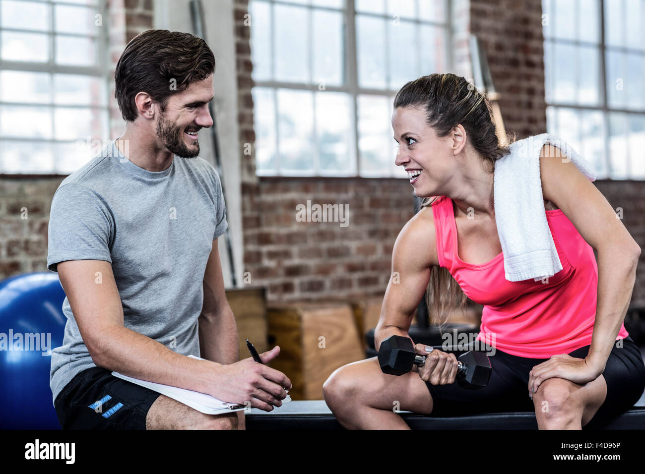 Smiling woman doing dumbbell exercises Stock Photo - Alamy