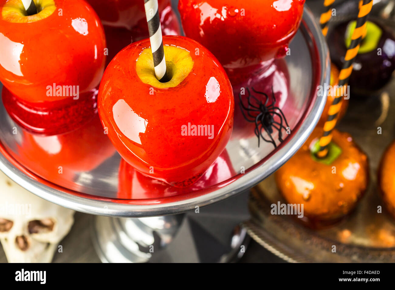 Table with colored candy apples for Halloween party Stock Photo - Alamy