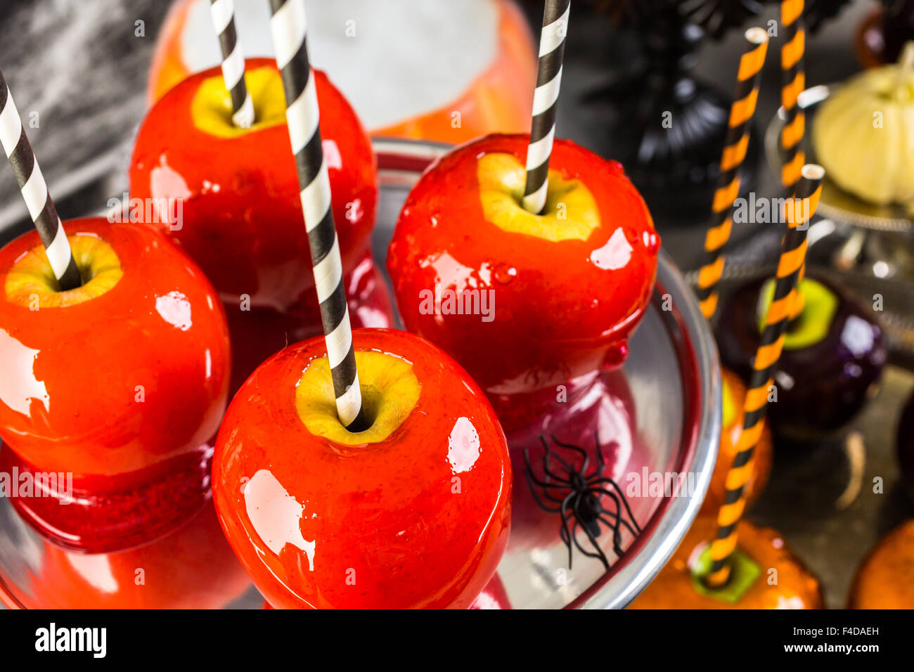 Table with colored candy apples for Halloween party Stock Photo - Alamy