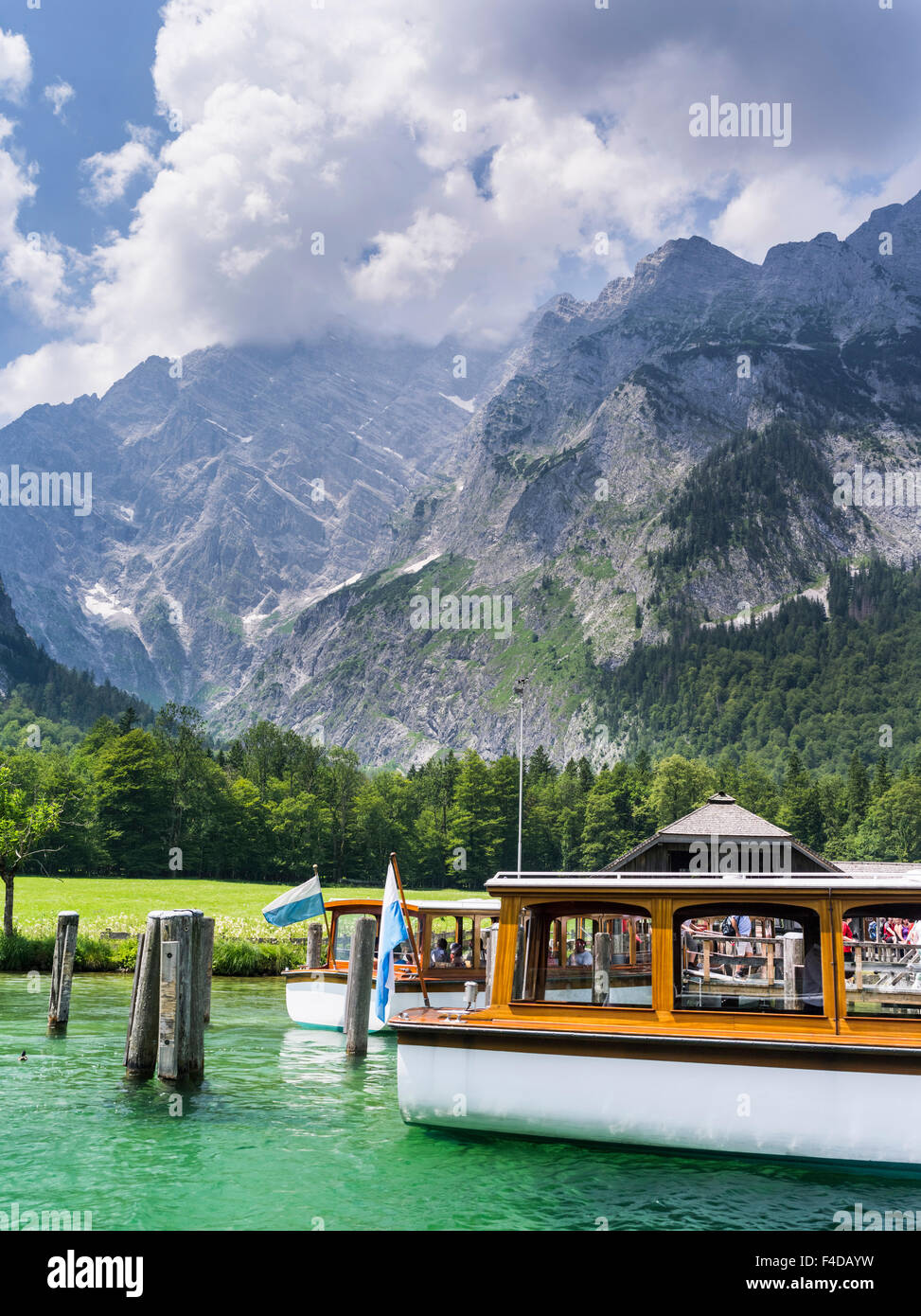The jetty of St. Bartholomae with excursion boats at lake Koenigssee ...