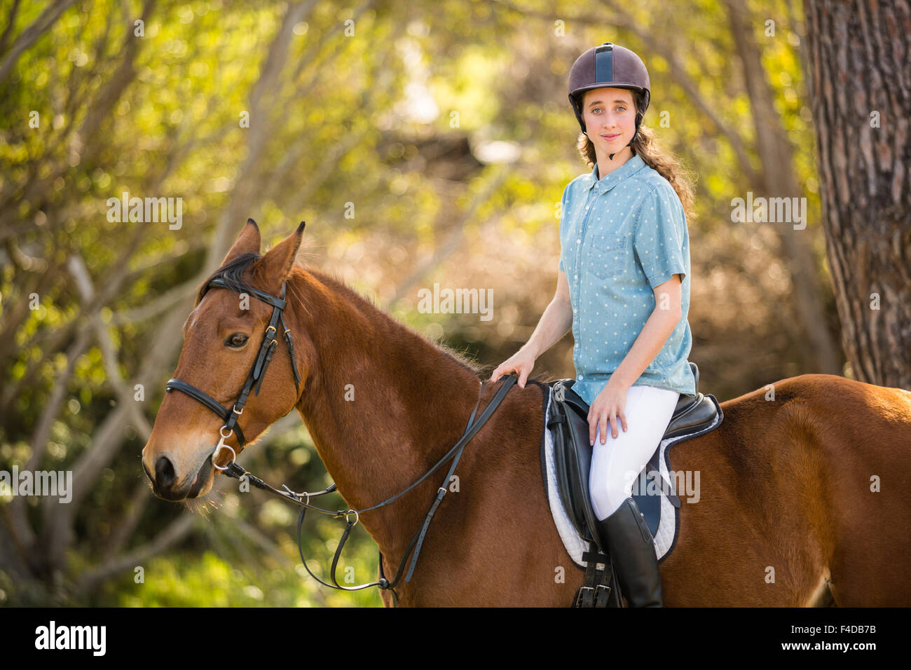 Happy woman riding her horse Stock Photo - Alamy