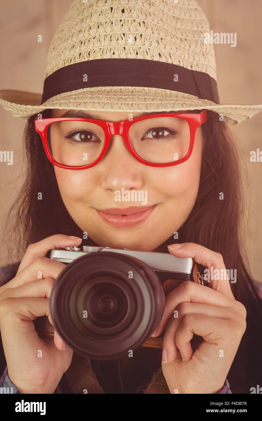 Attractive smiling hipster holding her camera Stock Photo - Alamy