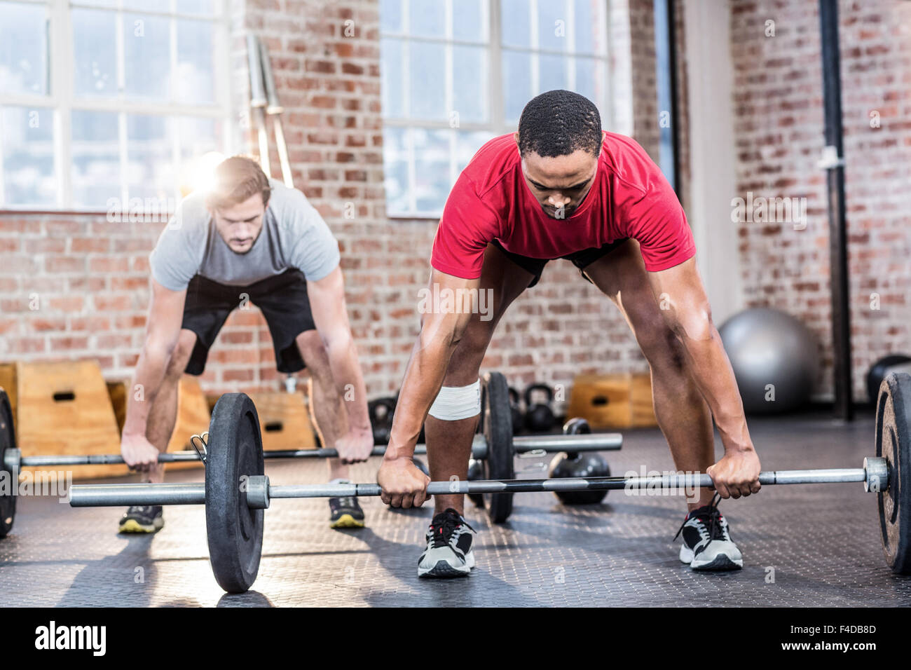 Fit people lifting a barbell Stock Photo - Alamy