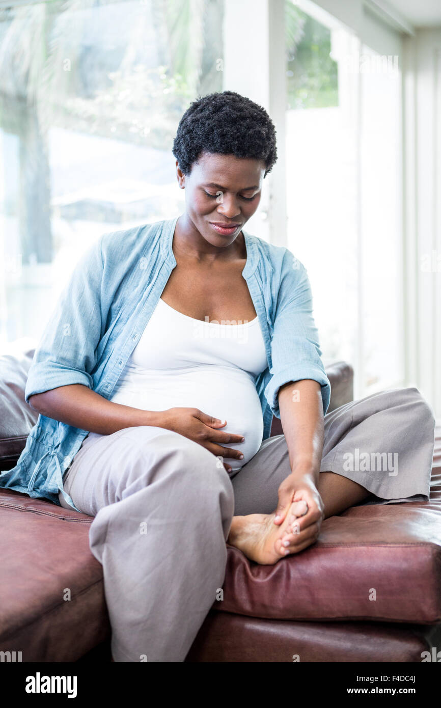 Woman massaging her tired feet Stock Photo - Alamy