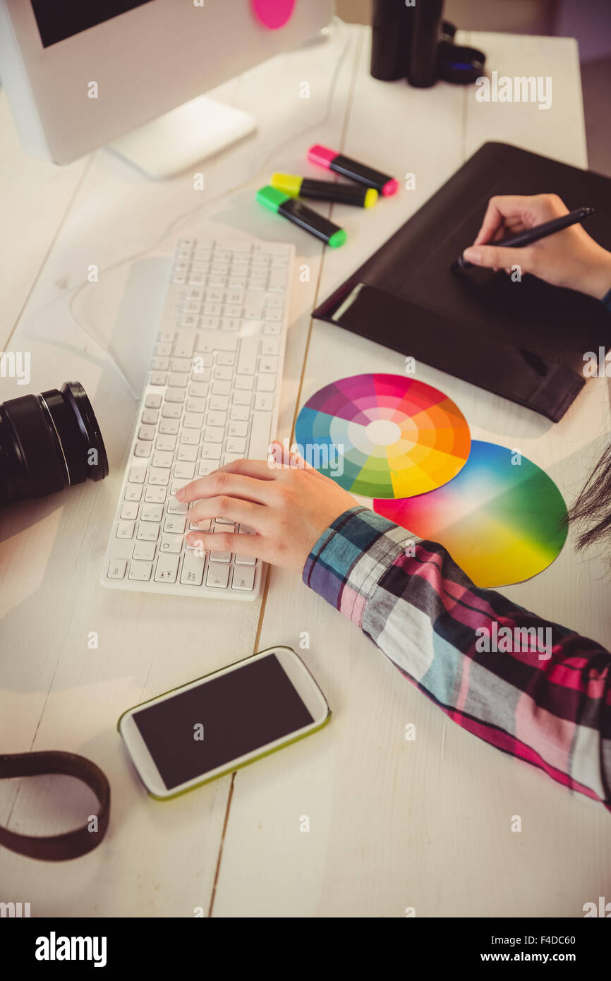 Young creative woman writing on a tablet Stock Photo - Alamy