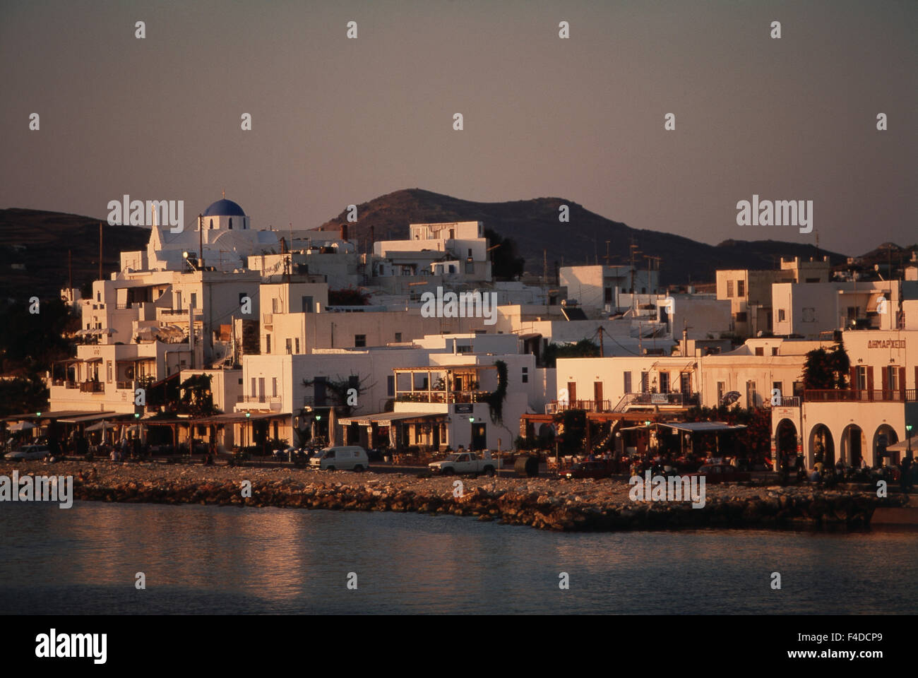 Greece, Cyclades Islands, Paros, Dusk. the town with harborfront ...