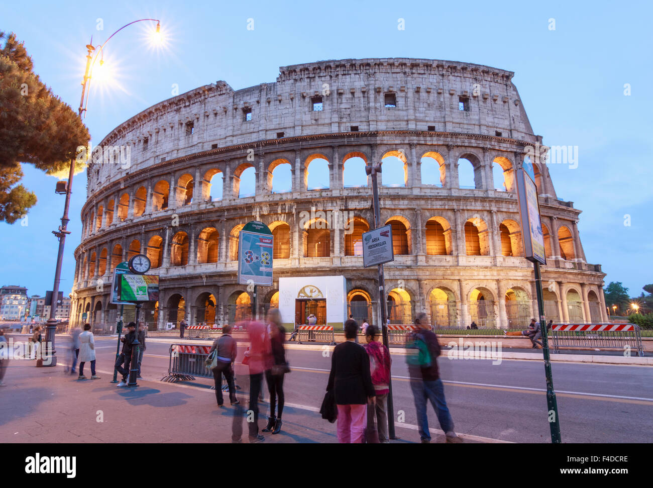 People at a bus stop next to the Coliseum at dusk. Rome, Italy Stock ...